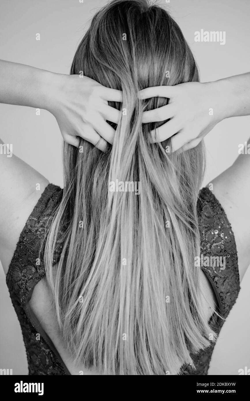 Tying back her white hair hi-res stock photography and images - Alamy