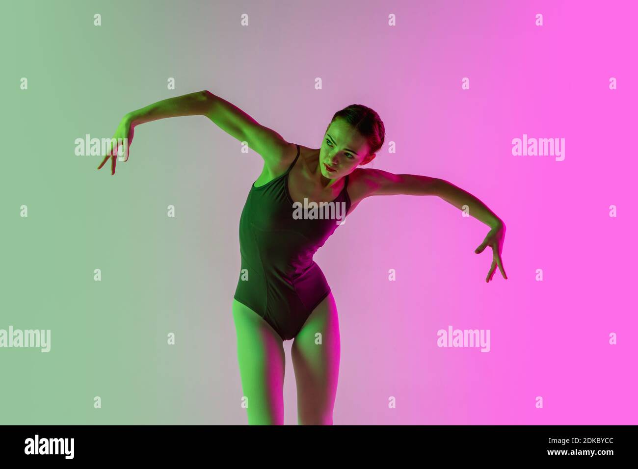 Gorgeous. Young and graceful ballet dancer isolated on gradient pink ...