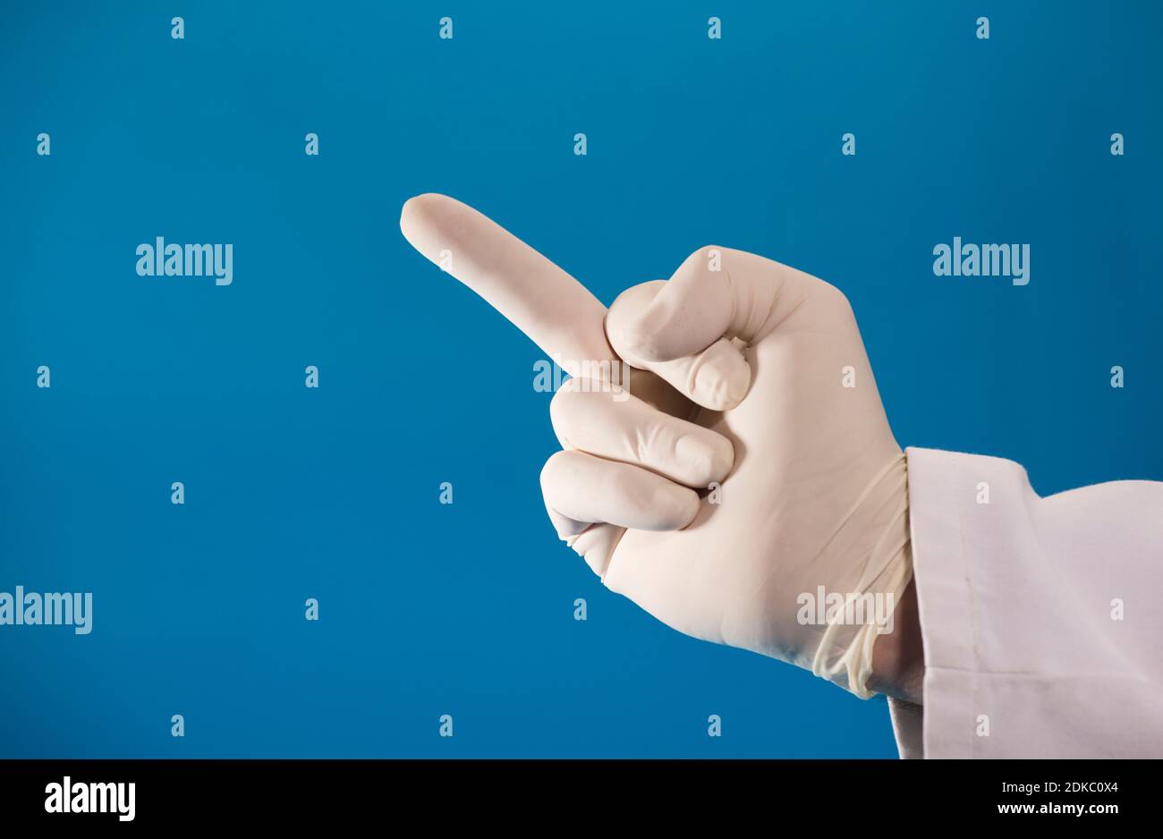 warning gesture doctor hand with surgical glove and blue background ...