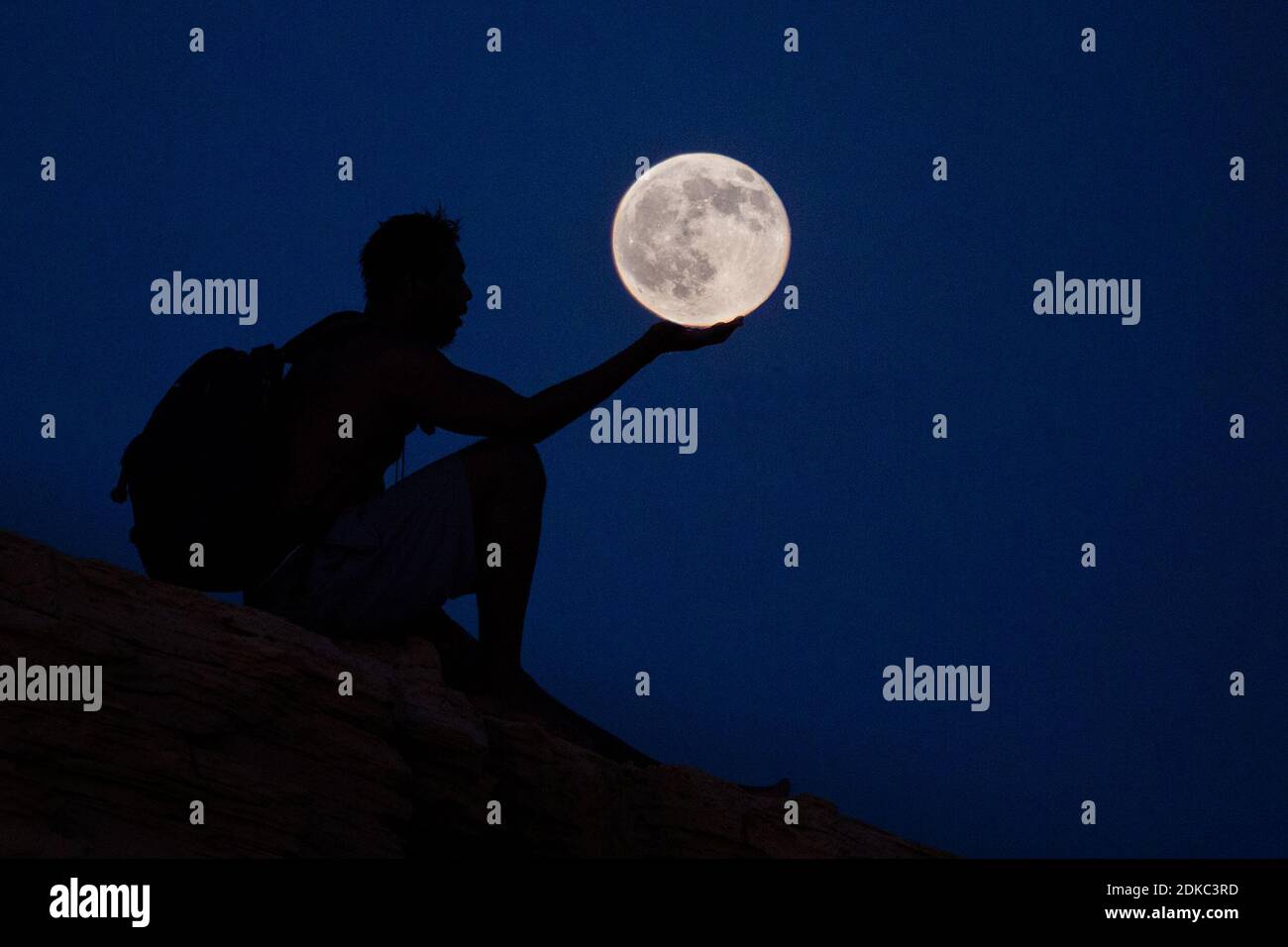 Holding the moon illusion hi-res stock photography and images - Alamy