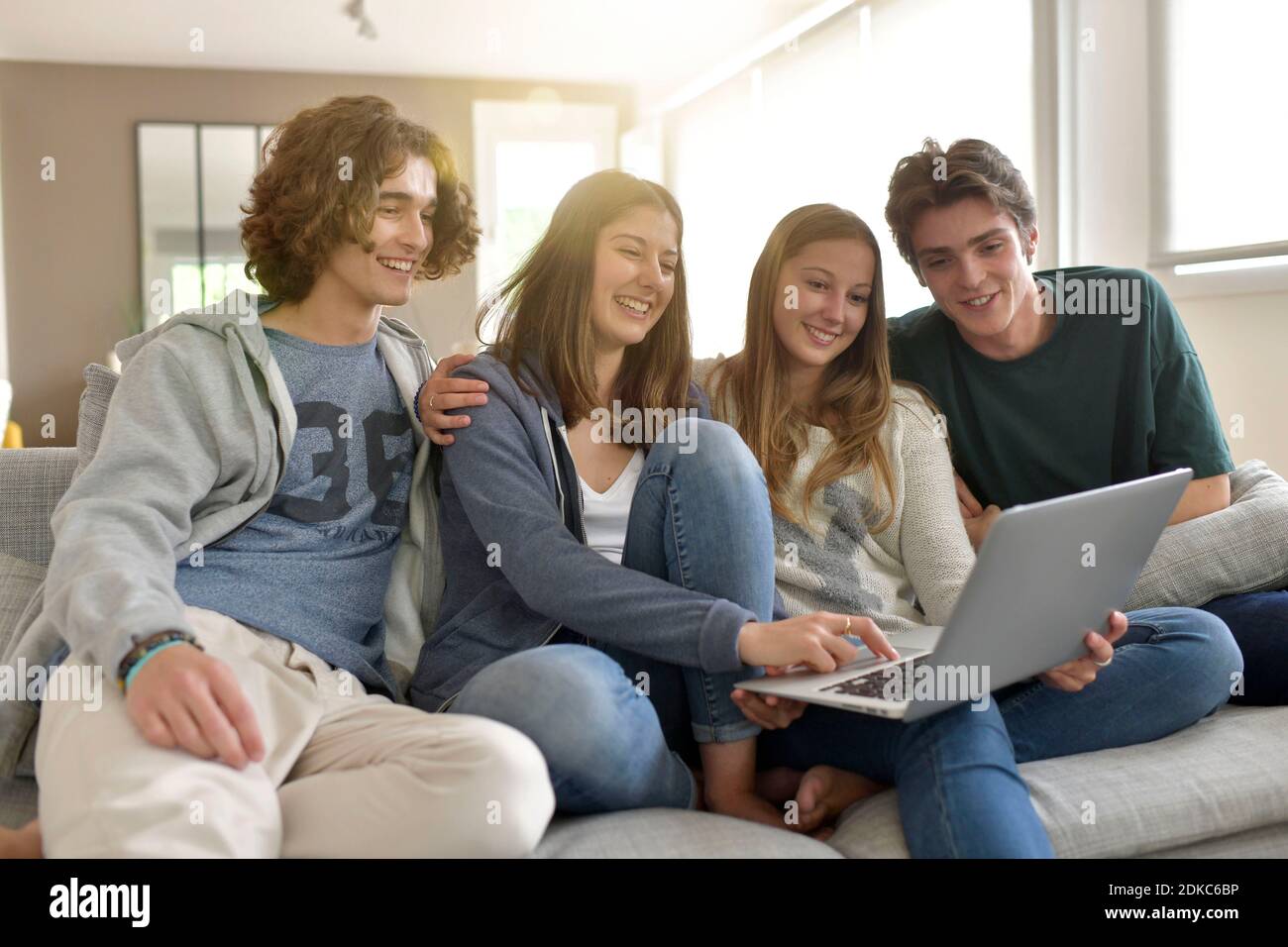 Friends having fun at home connected on laptop Stock Photo - Alamy