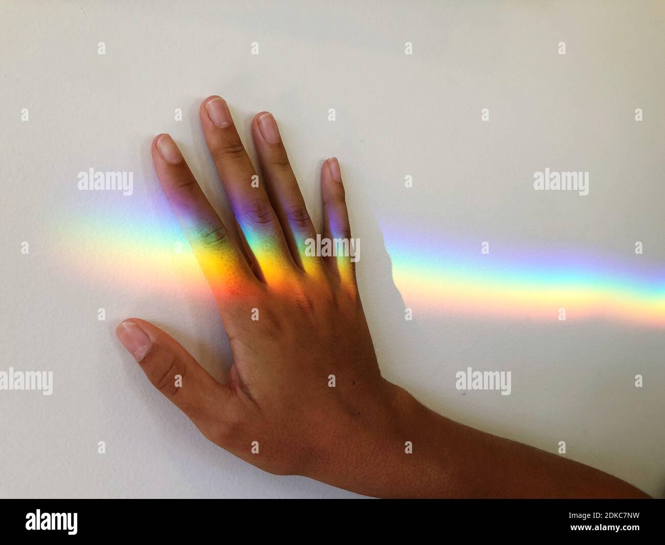 Rainbow touching hand hi-res stock photography and images - Alamy