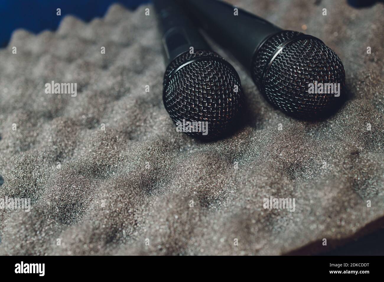 Two silver microphones isolated over white background . Two wireless ...
