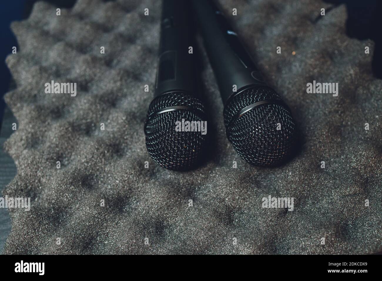 Two silver microphones isolated over white background . Two wireless ...
