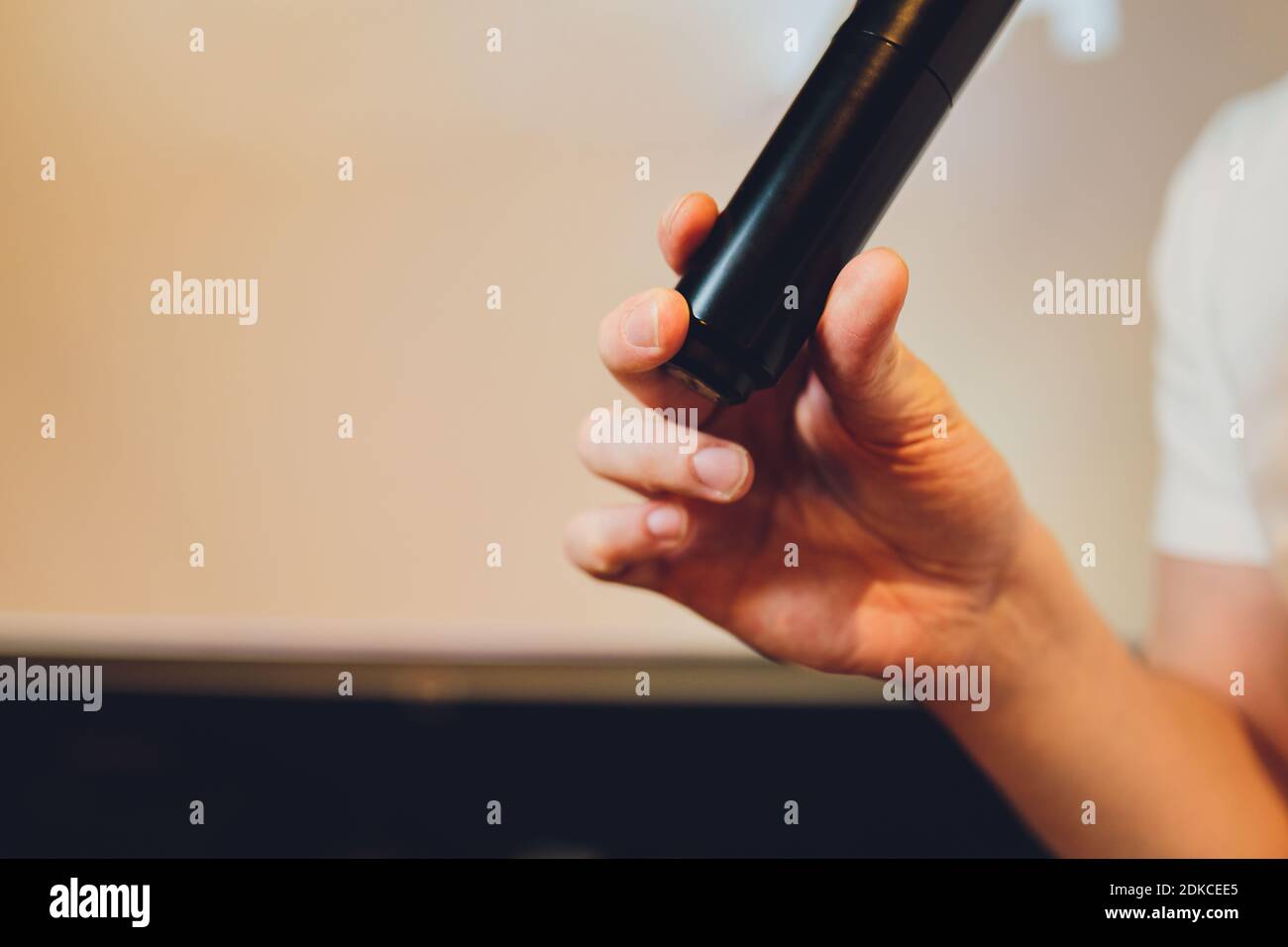 Microphone and unrecognizable female singer close up. Cropped image of ...