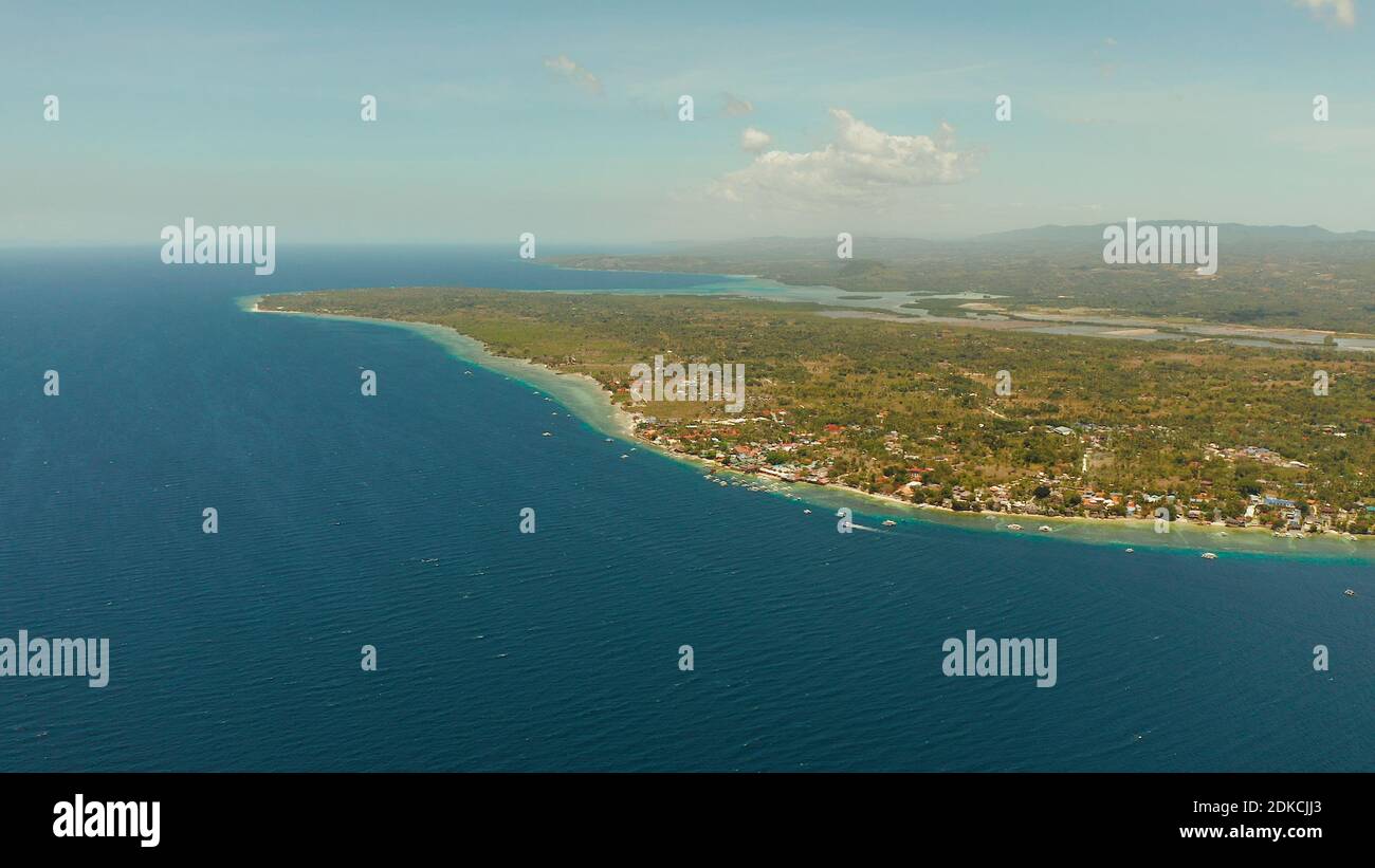 Coral reef and turquoise water with Philippine boats in the famous ...