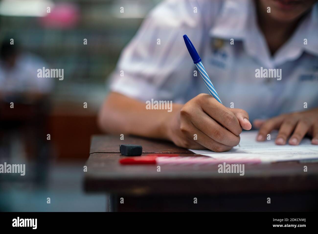 Students taking exam with stress in school classroom Stock Photo - Alamy