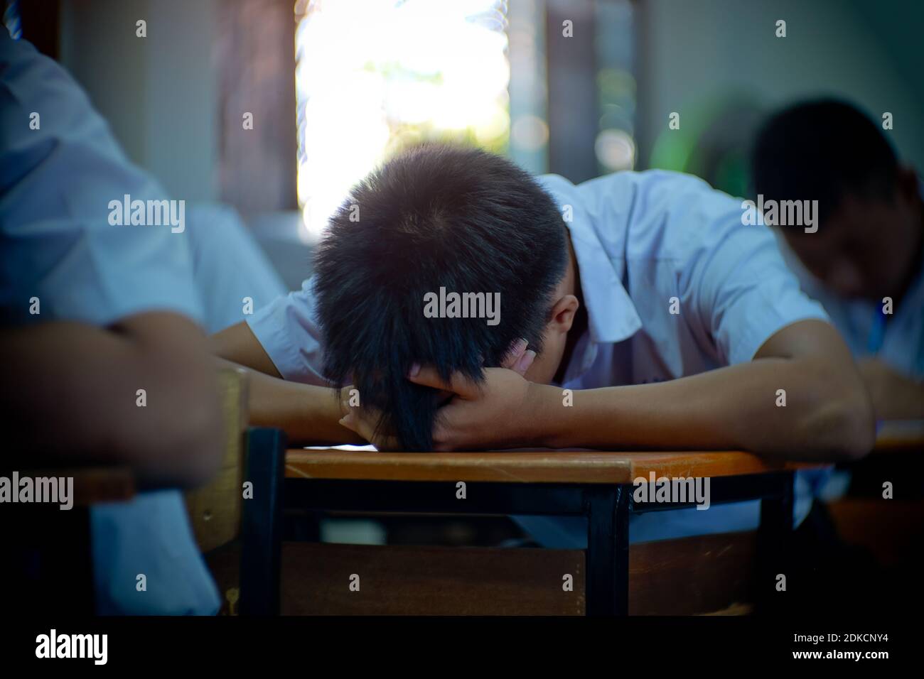 Students taking exam with stress in school classroom Stock Photo - Alamy