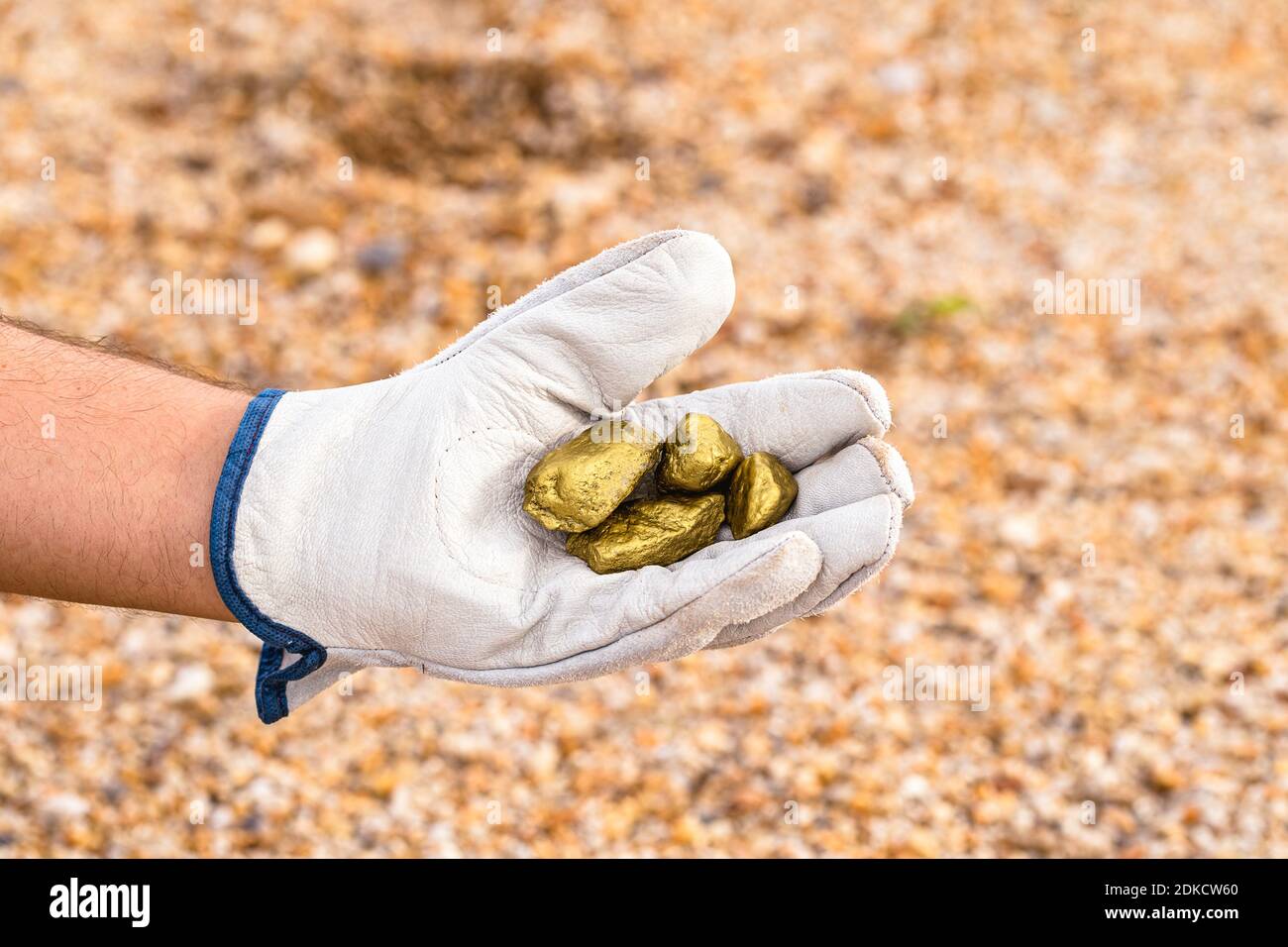 Gold nuggets, hand hi-res stock photography and images - Alamy