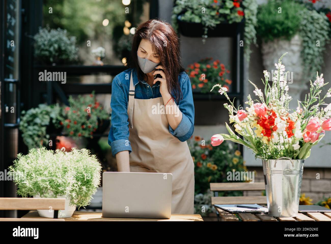Flowers delivery, creating order. Millennial busy owner woman looks at ...