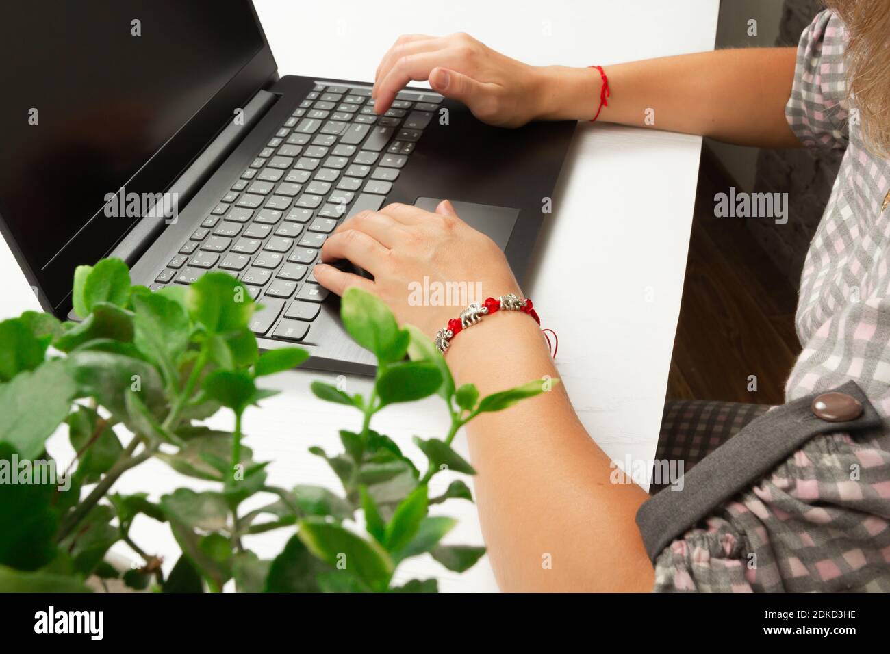 girl typing text on laptop keyboard on white wooden table background ...