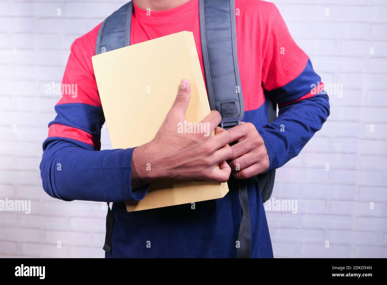 young boy hand holding stack of books on white background Stock Photo ...