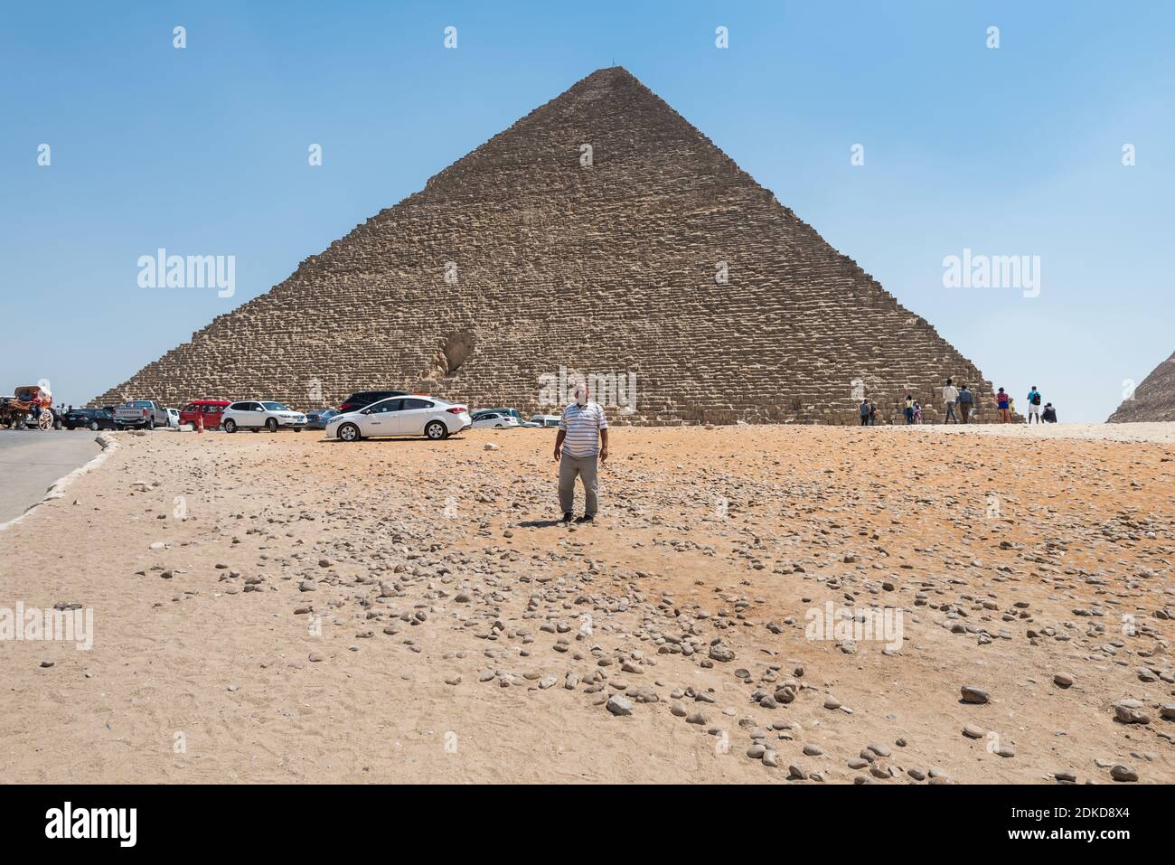 A lonely Egyptian man standing in front of Pyramid of Khufu in The Giza ...