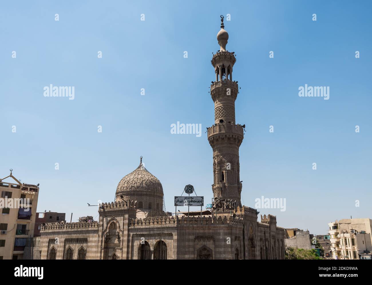 Street view of Cairo, a mosque with a tall minaret in the old downtown ...