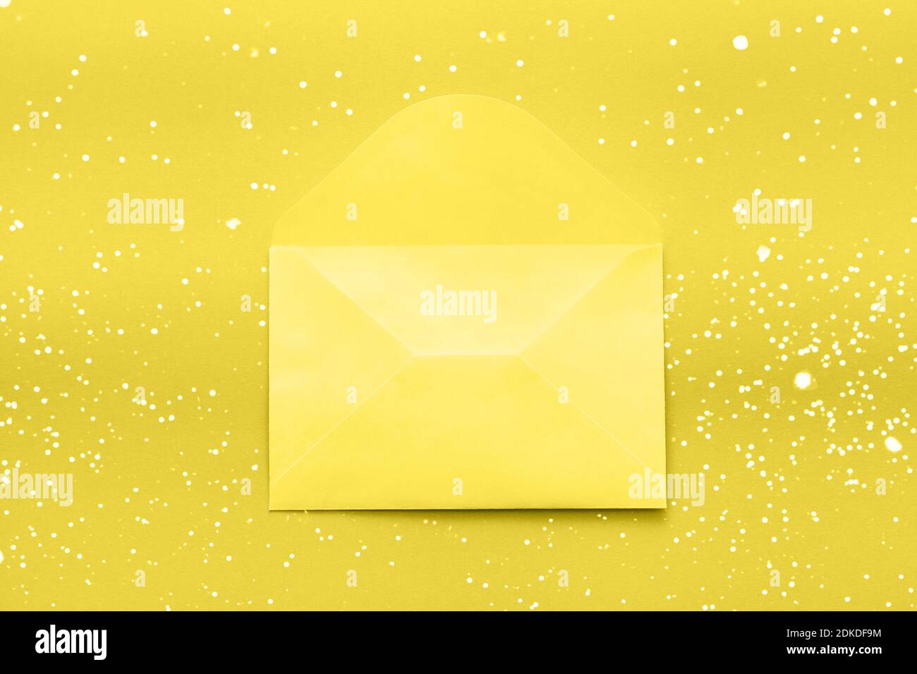 Color trend 2021 - Yellow envelope on a yellow background. Flat lay ...