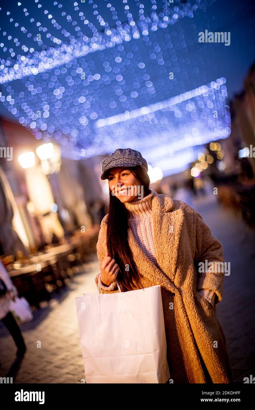 Beautiful young woman on the street at cold Christmas night Stock Photo ...