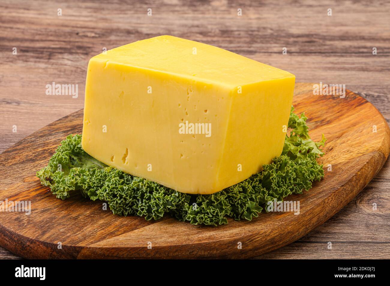 Yellow tilsiter cheese dairy product brick Stock Photo - Alamy