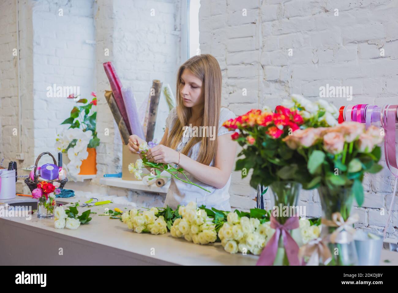 Professional floral artist working with flowers at studio Stock Photo ...