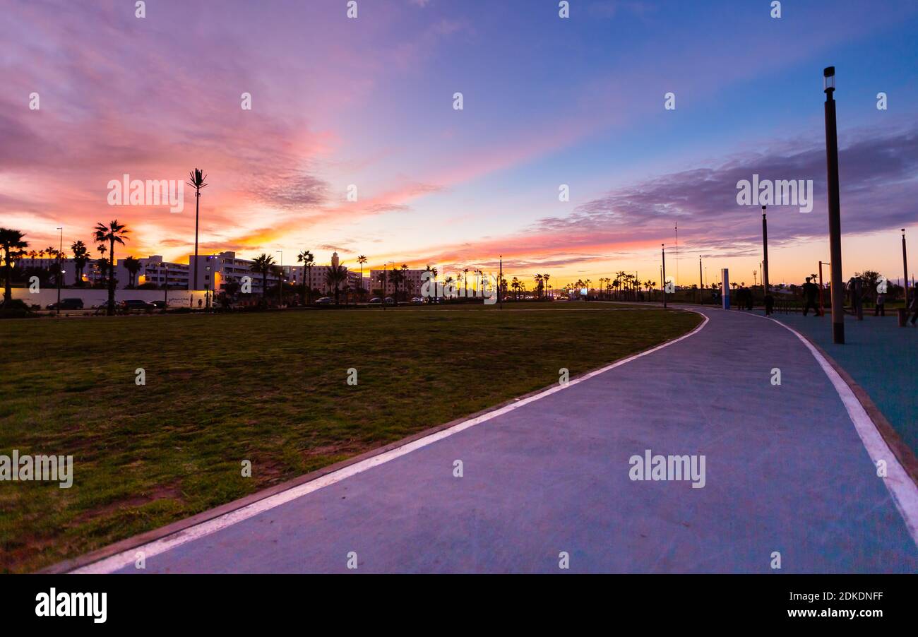 A curved way and colorful sunset sky Stock Photo - Alamy
