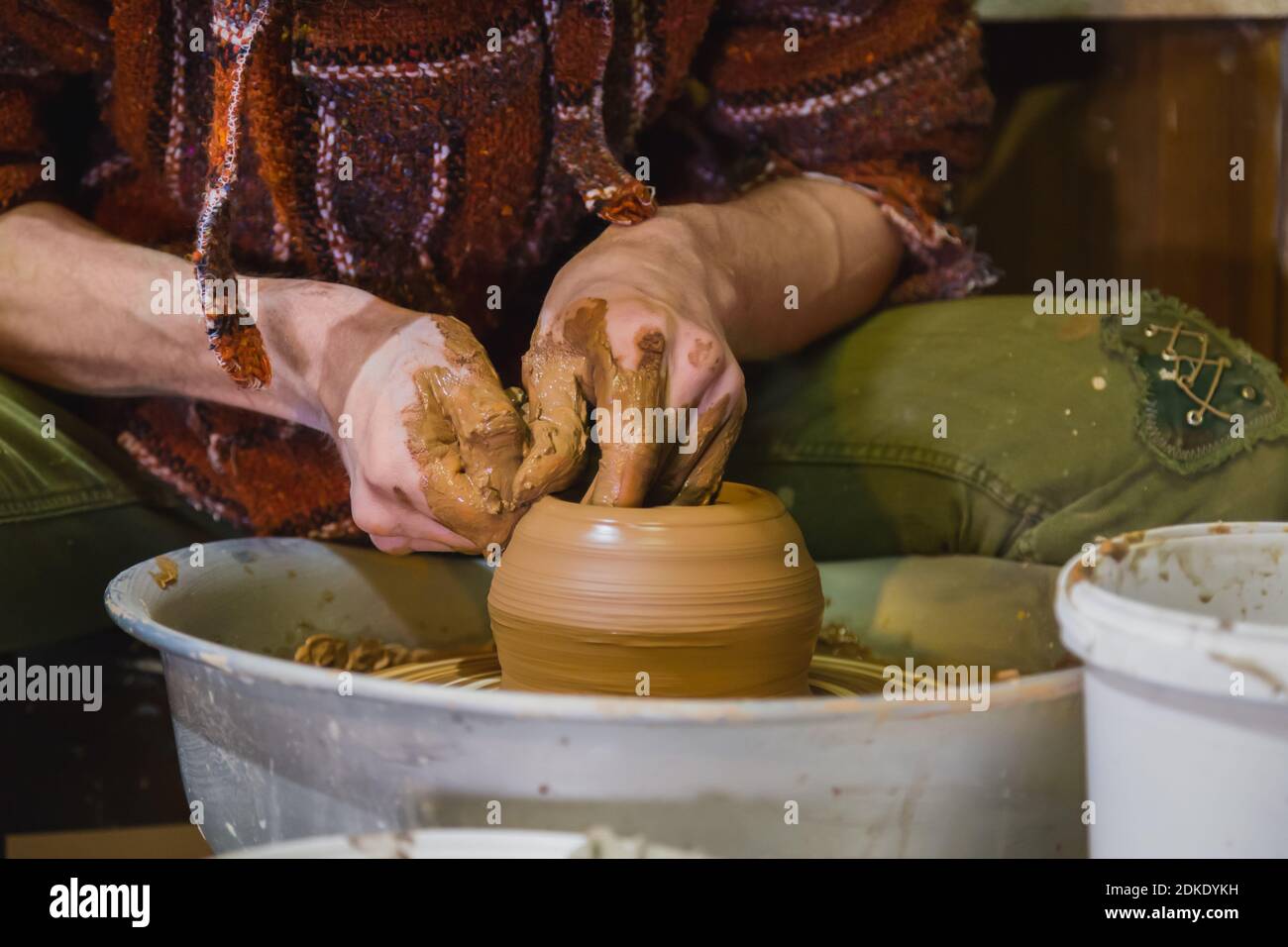 Professional male potter making pot in pottery workshop Stock Photo - Alamy