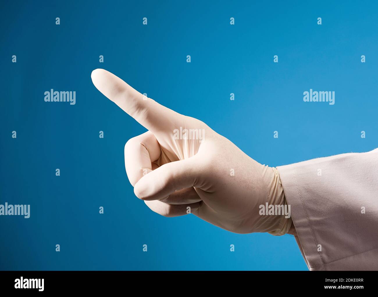 warning gesture doctor hand with surgical glove and blue background ...