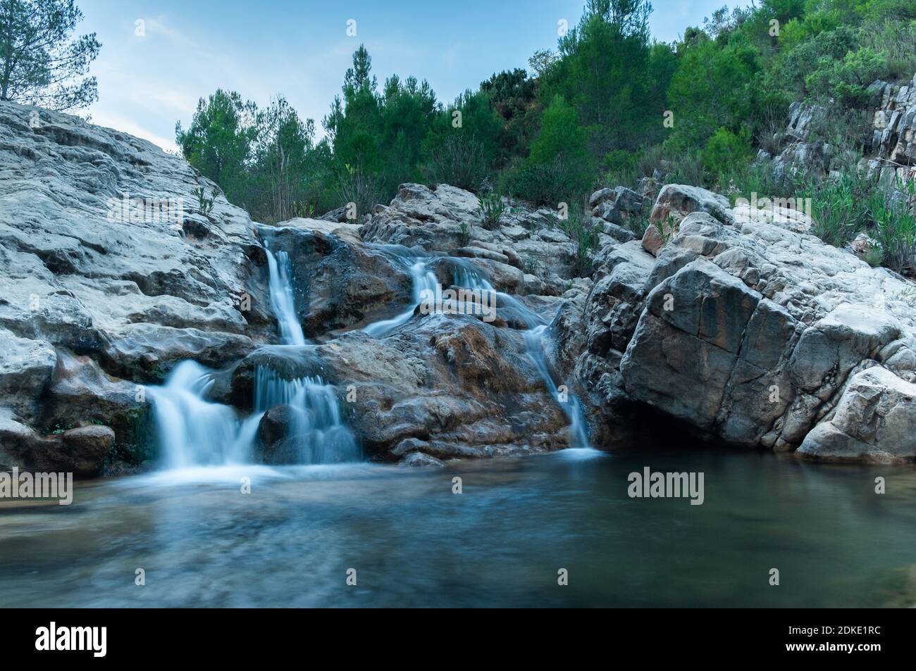 A small beautiful waterfall with the rocks Stock Photo - Alamy