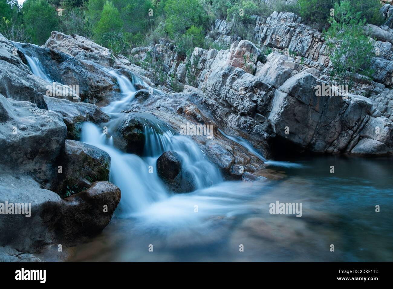 A small beautiful waterfall with the rocks Stock Photo - Alamy