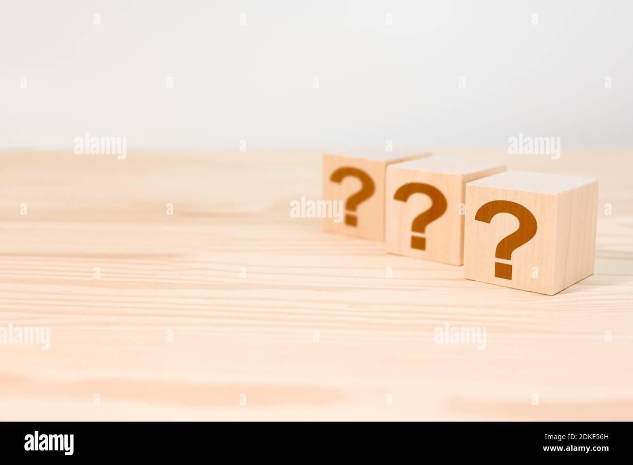 Cubes with question marks on wooden background, closeup. Wooden cube ...