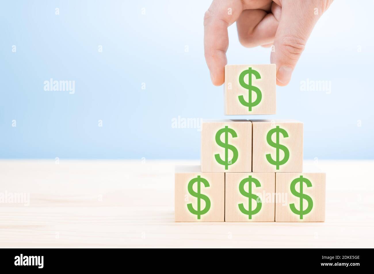 pyramid made of wooden blocks with dollars. Increase, rise, grow, up ...