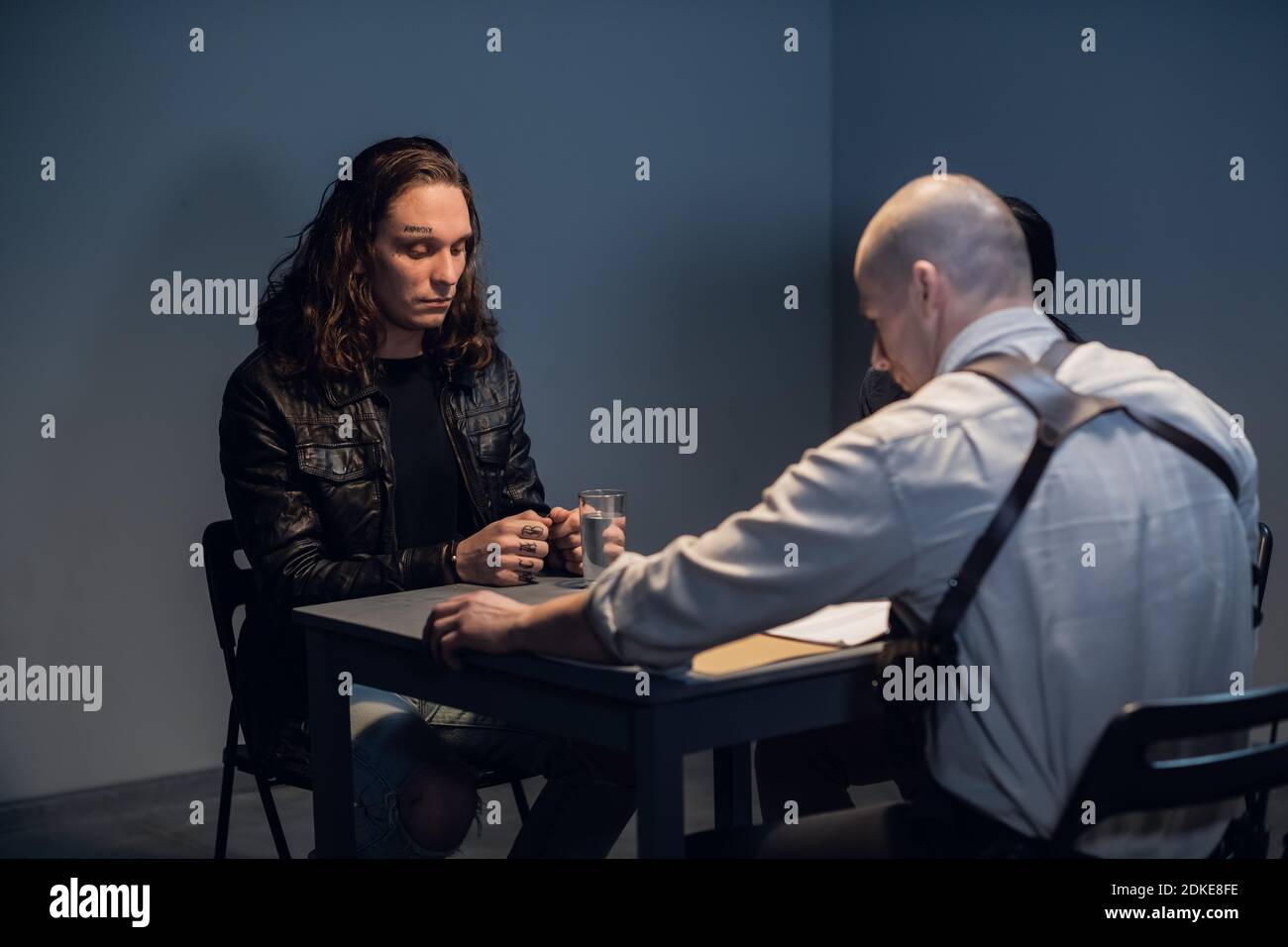 An experienced investigator and his assistant conduct an interview at ...