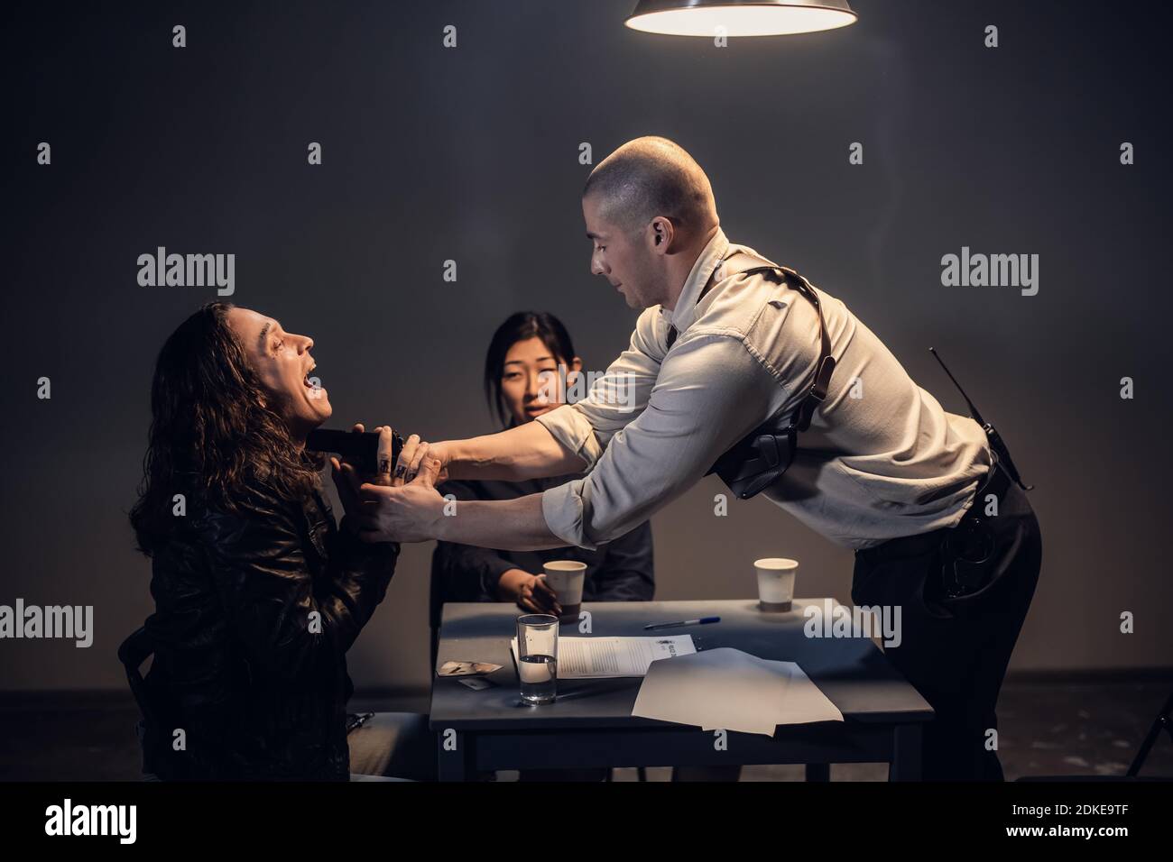 A corrupt police officer brutally tortures a detained man with tattoos ...