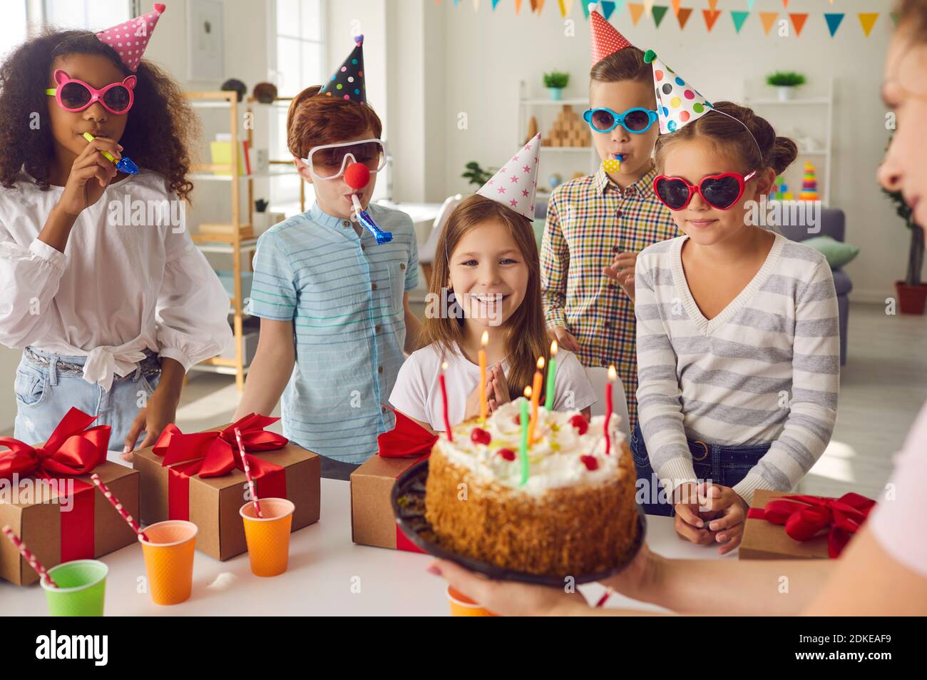 Group of happy diverse kids celebrating their friend's birthday at fun ...