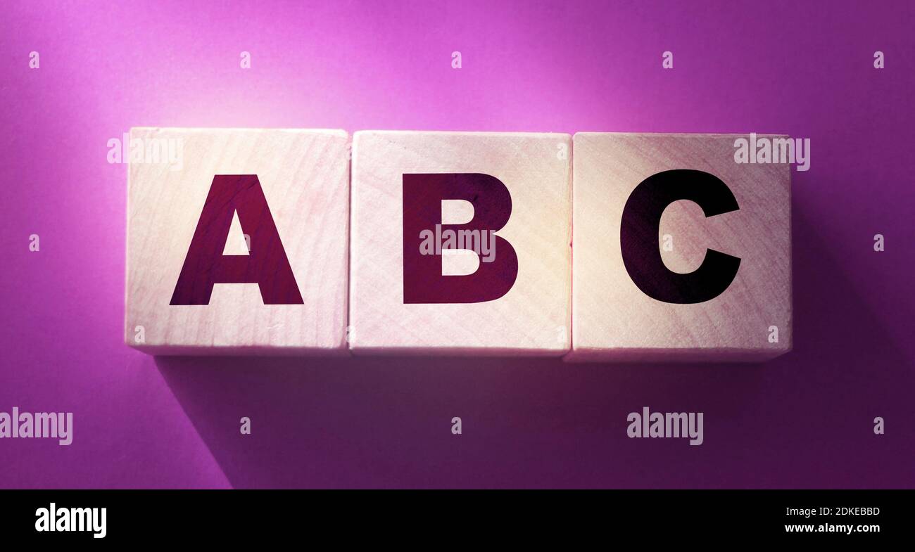 ABC letters wooden blocks on purple background. Education concept Stock ...