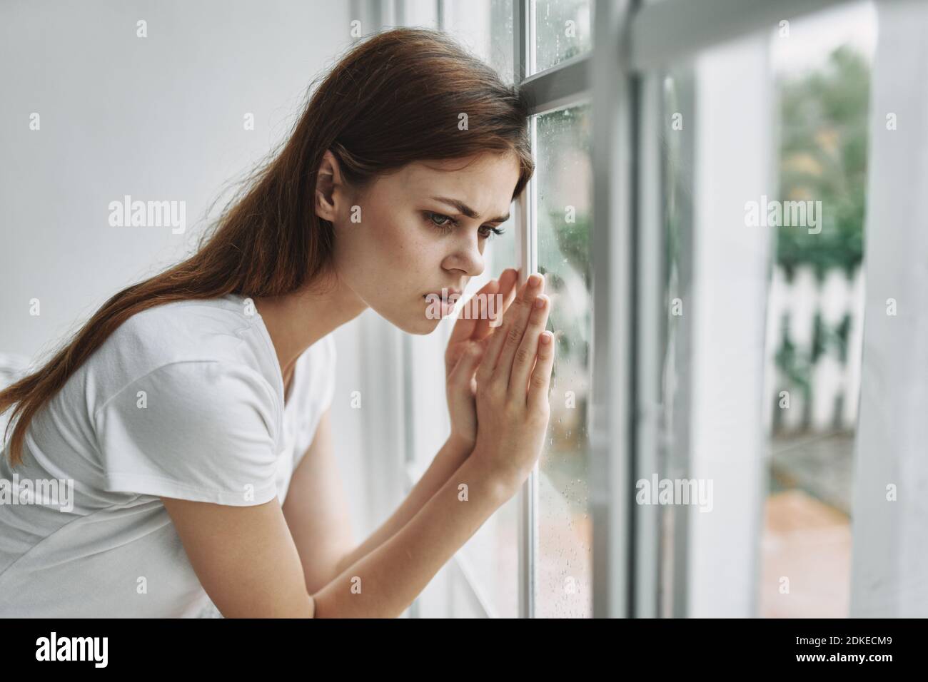 Exhausted woman looking out of window hi-res stock photography and ...