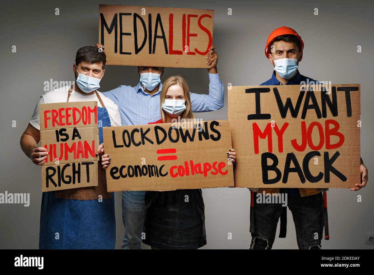 Group of protesters standing with placards against lockdowns Stock ...