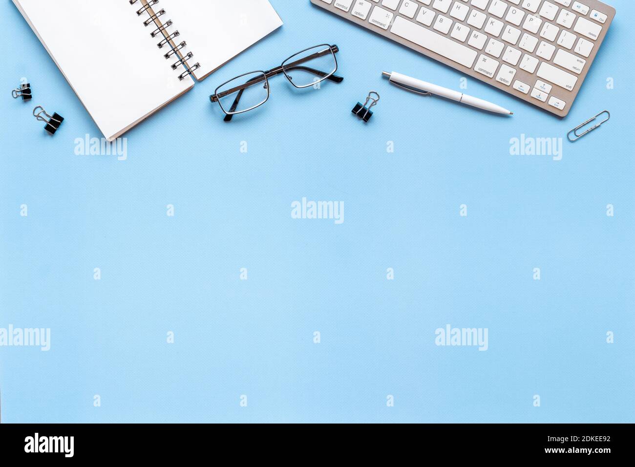 Blue flat lay top view office table desk with keyboard and office ...