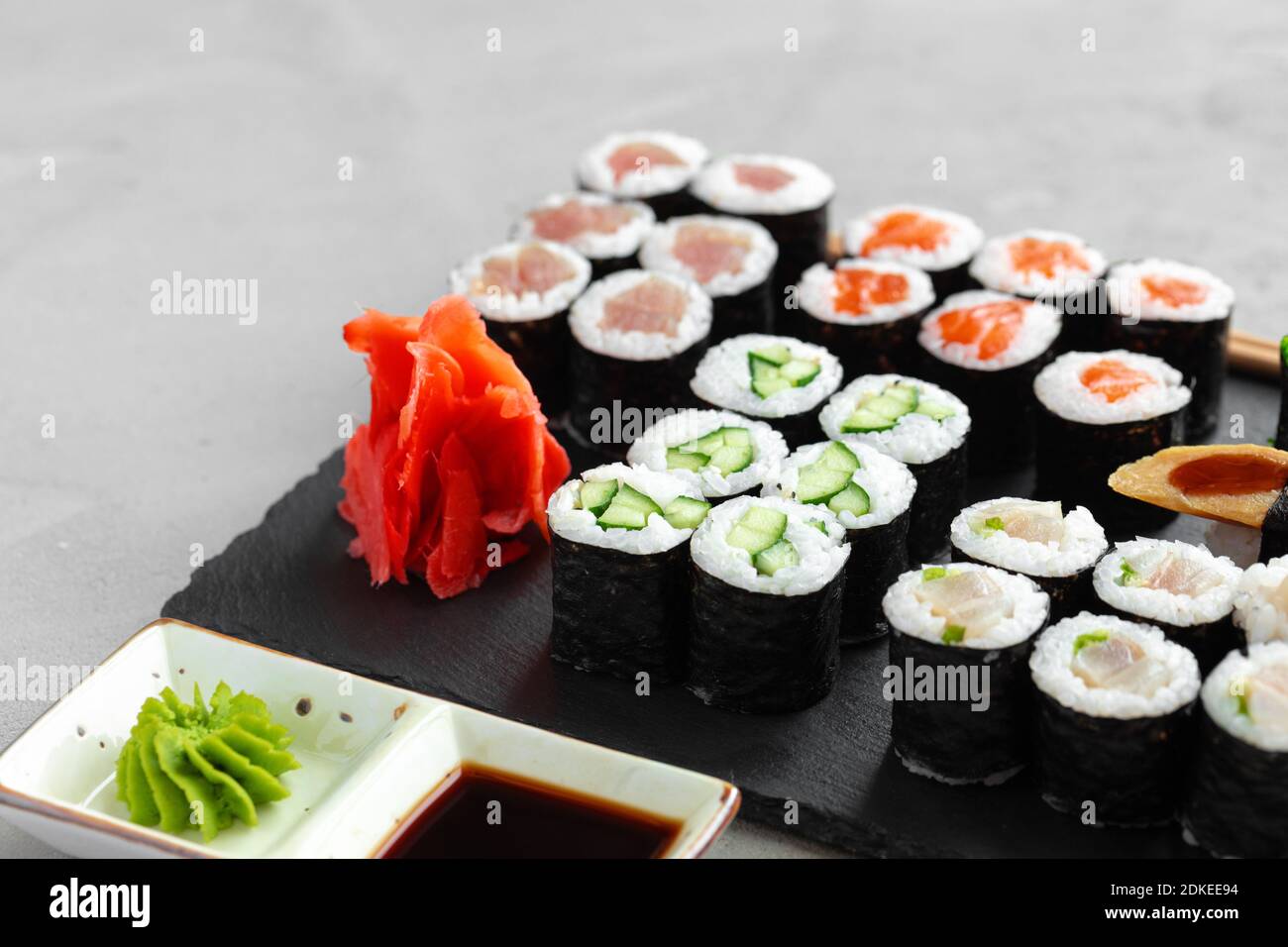 Maki sushi set served on black stone tray Stock Photo - Alamy