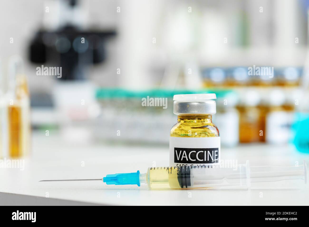 Vaccine in vial for injection on table against background of laboratory ...