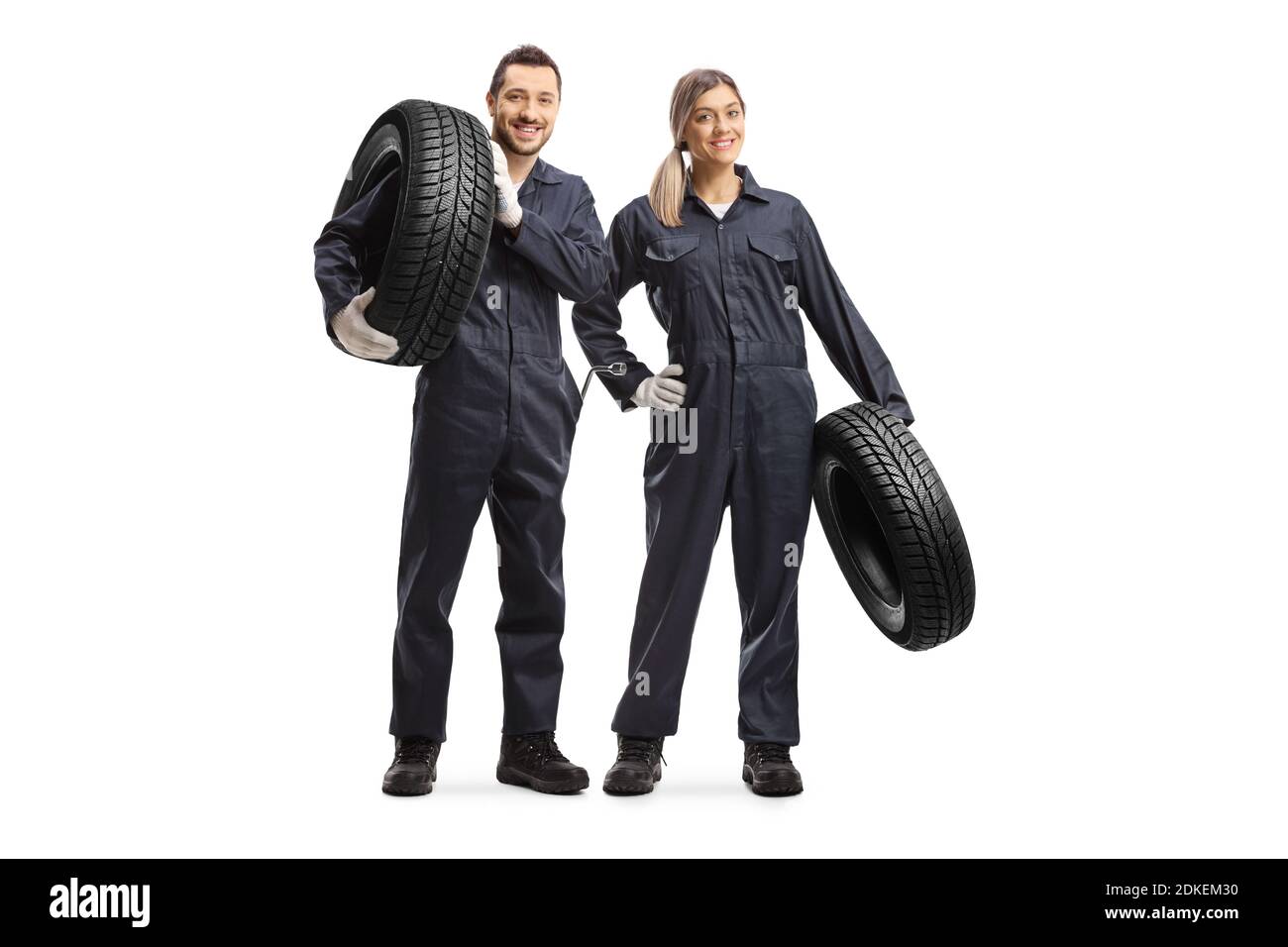 Male and female auto mechanic workers carrying car tires isolated on ...