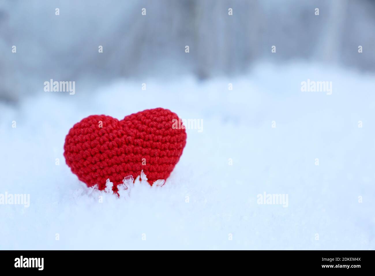 Valentines heart on a snow in winter park. Background for Christmas ...