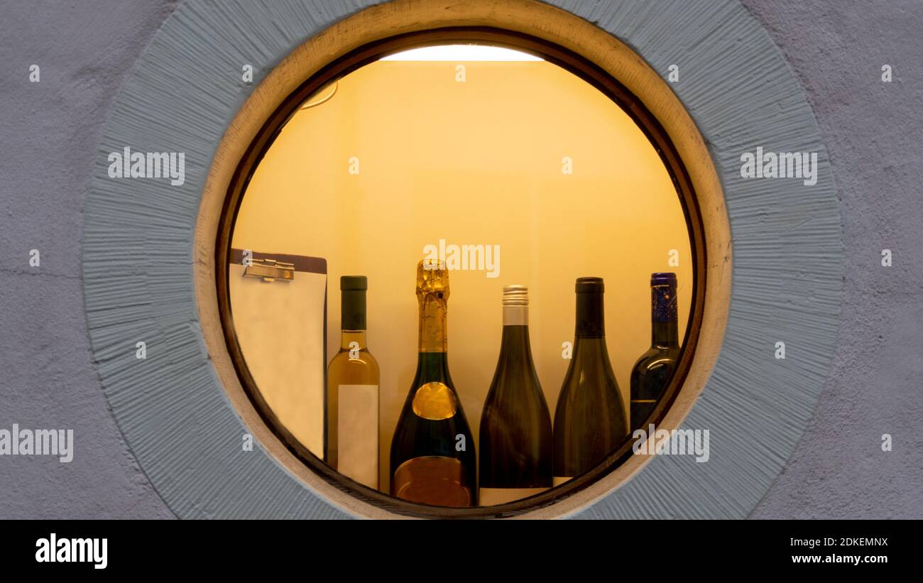 Round illuminated shop window with wine selection Stock Photo - Alamy