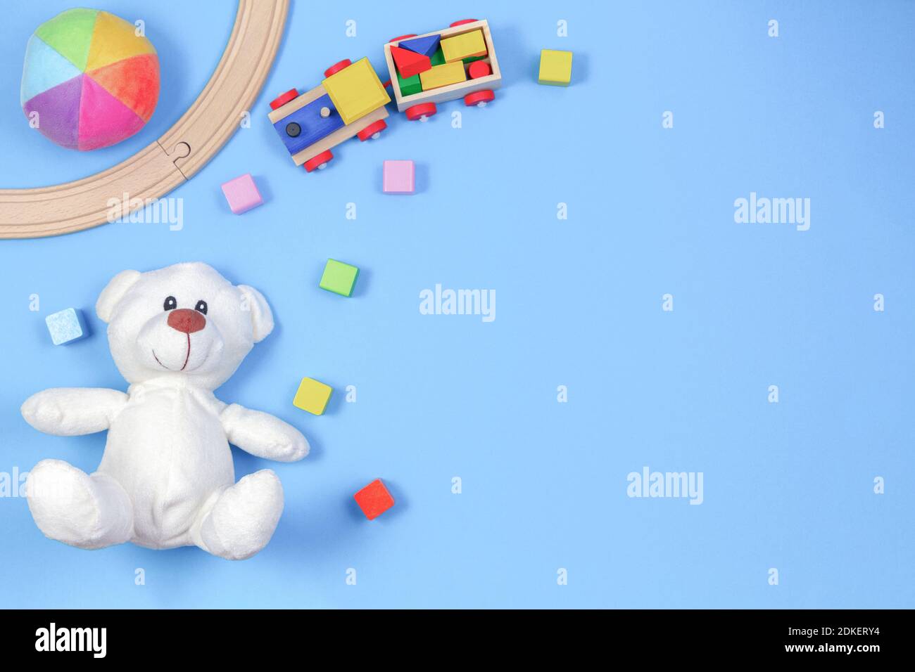 Kids toys background with teddy bear, wooden train and colorful blocks ...