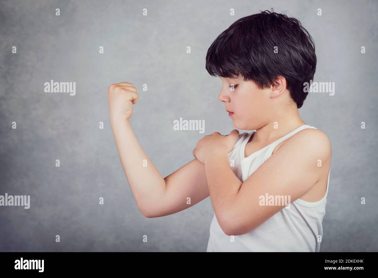 Close-up Of Boy Flexing Muscles Against Wall Stock Photo - Alamy