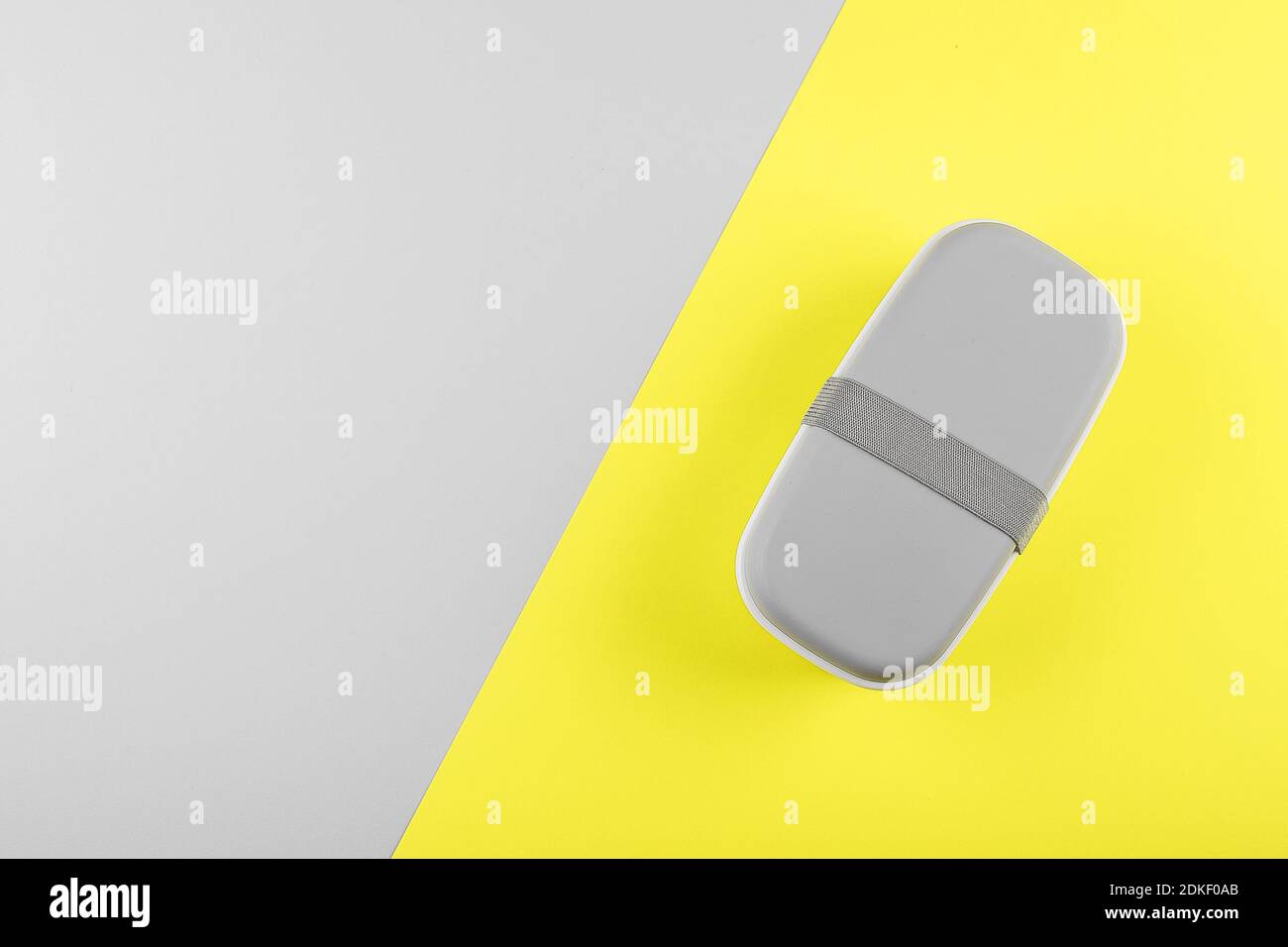 Gray lunch box on gray yellow background. Concept of color of the year ...