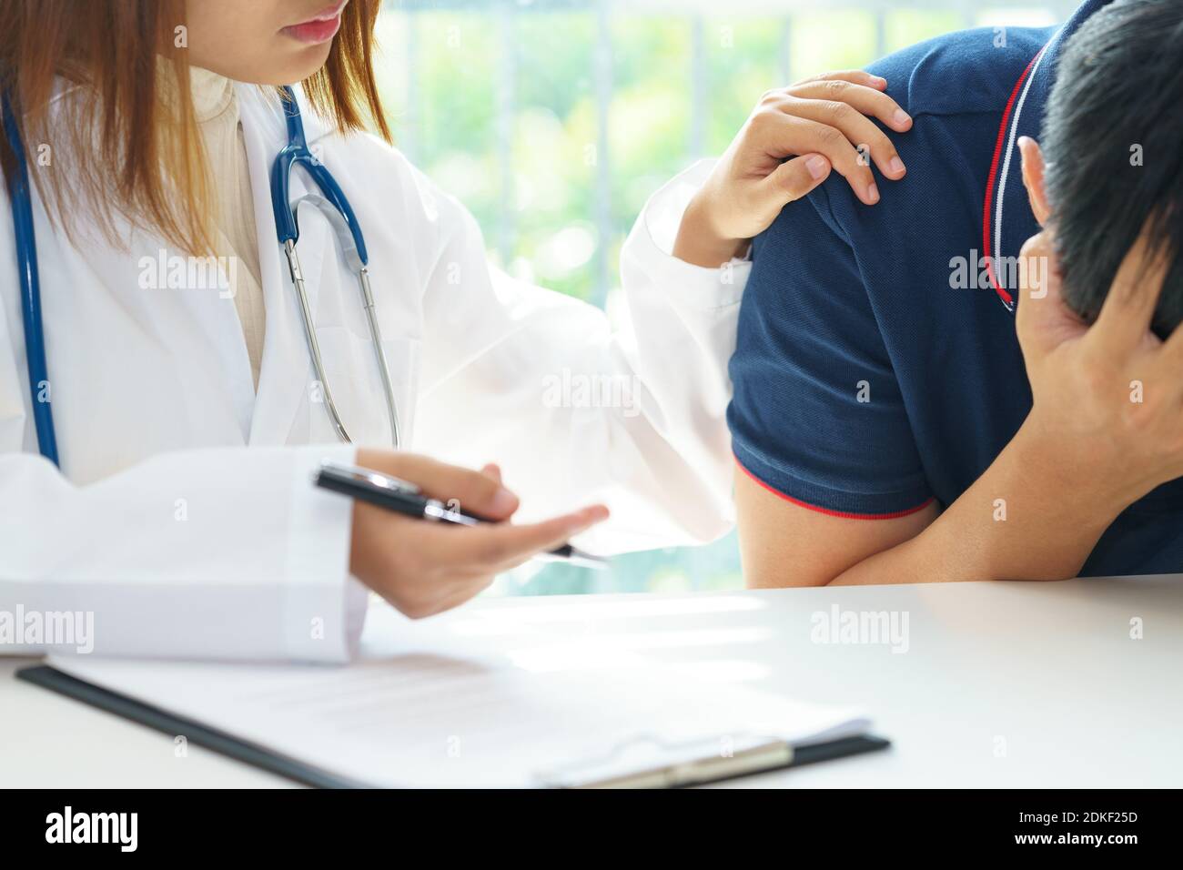 Female doctor touching patient shoulder for cheerful Stock Photo - Alamy