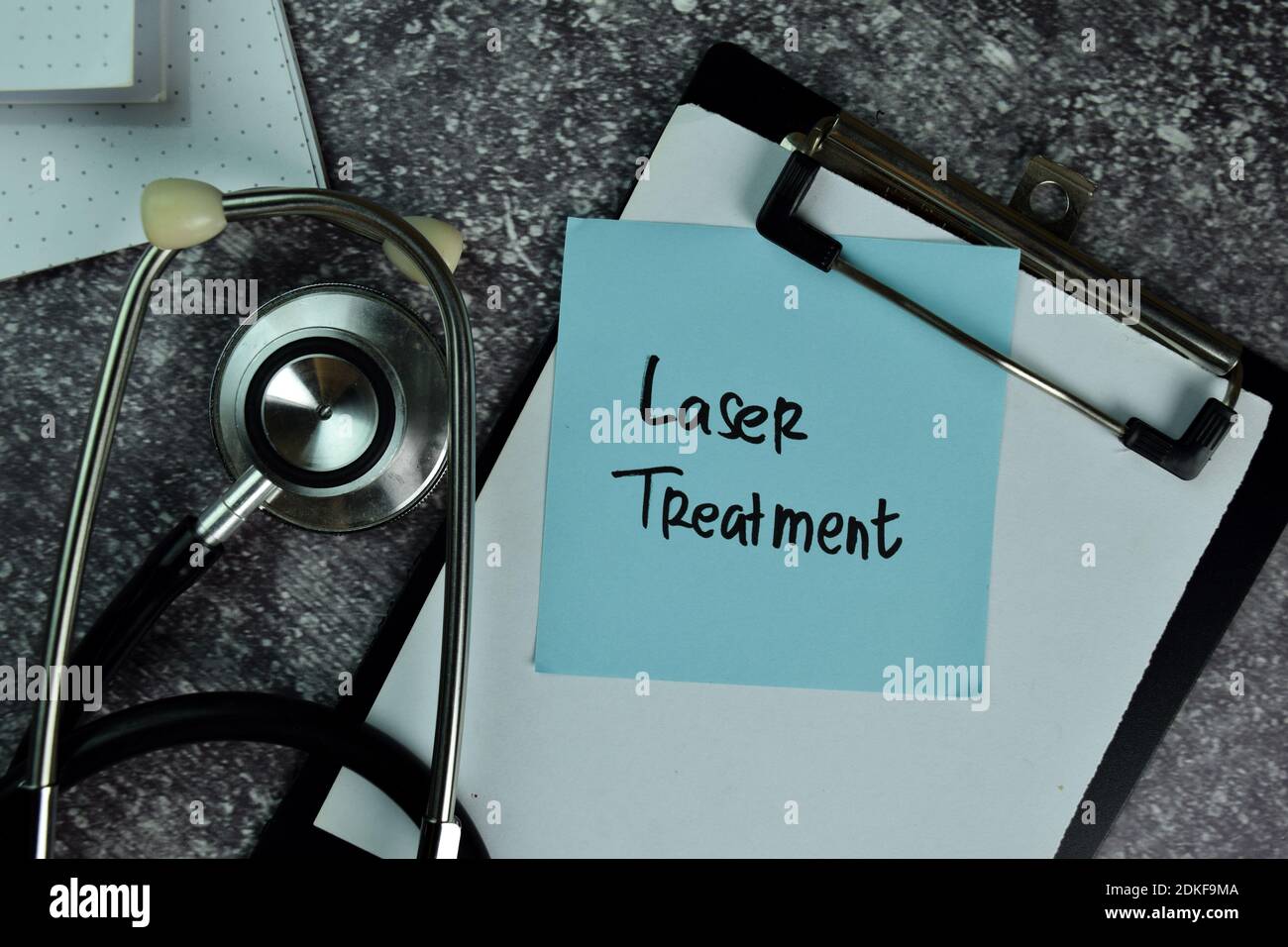 Laser Treatment write on sticky notes on the table. Medical or ...