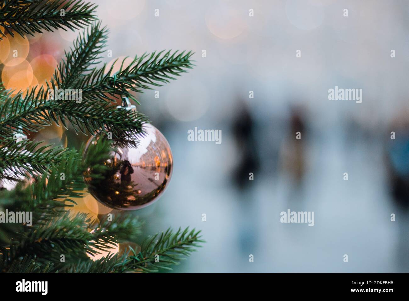 Brown glass balls on Christmas tree big on blurry background. Selective ...