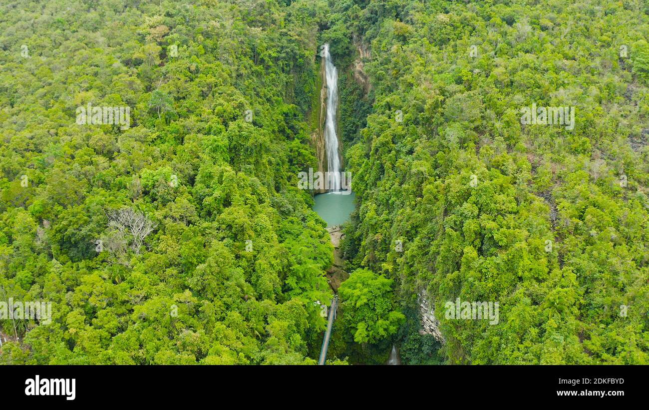 Aerial view of Mantayupan waterfalls in a mountain gorge in the tropical jungle, Philippines ...