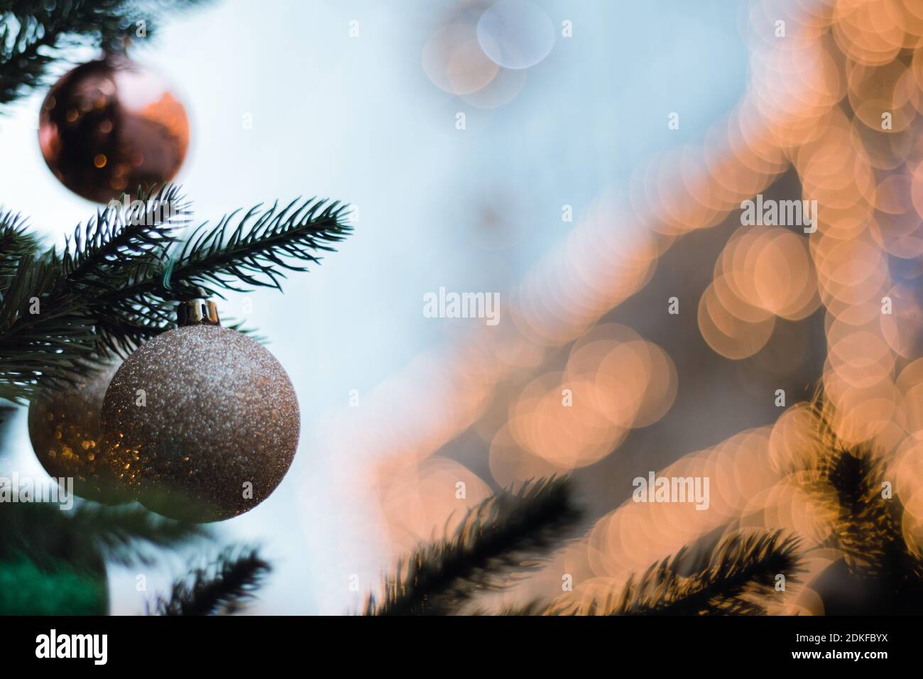 Brown glass balls on Christmas tree big on blurry background. Selective ...