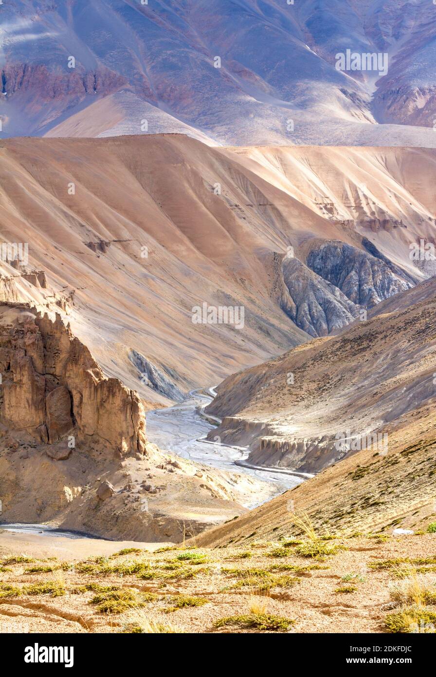 Winding road through a gorge in the Himalayas among colorful mountains ...